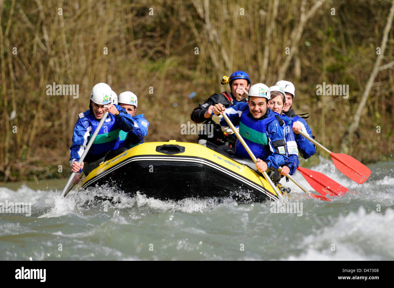 Young tourists practice rafting with a guide in Sella river in an ...