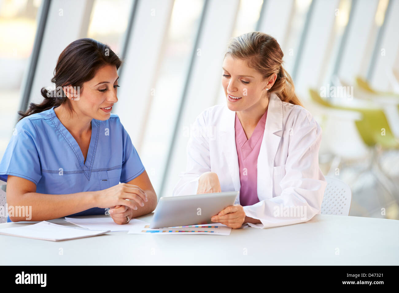 Female Doctor And Nurse Having Meeting In Hospital Canteen Stock Photo ...