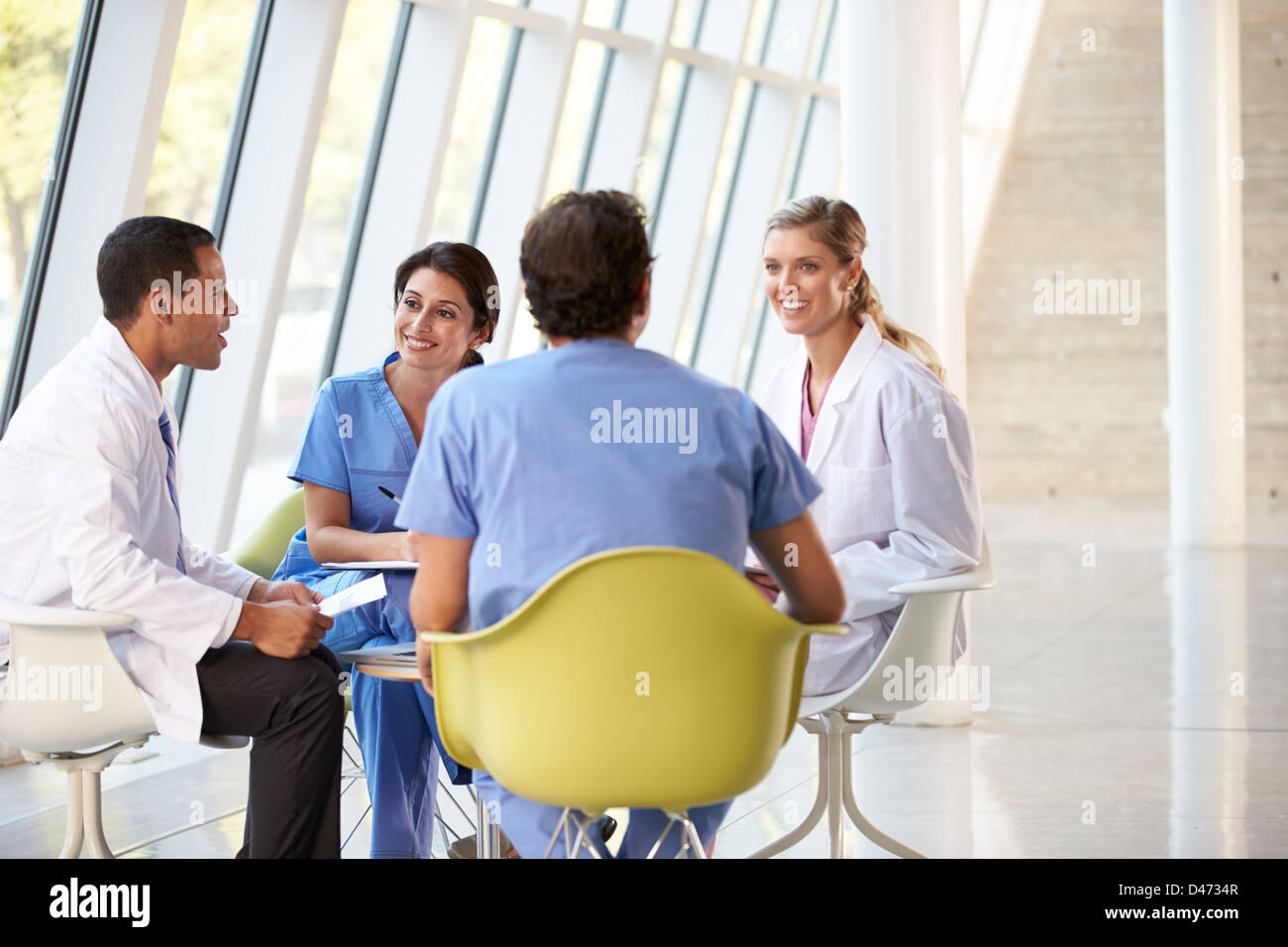 Medical Team Meeting Around Table In Modern Hospital Stock Photo - Alamy