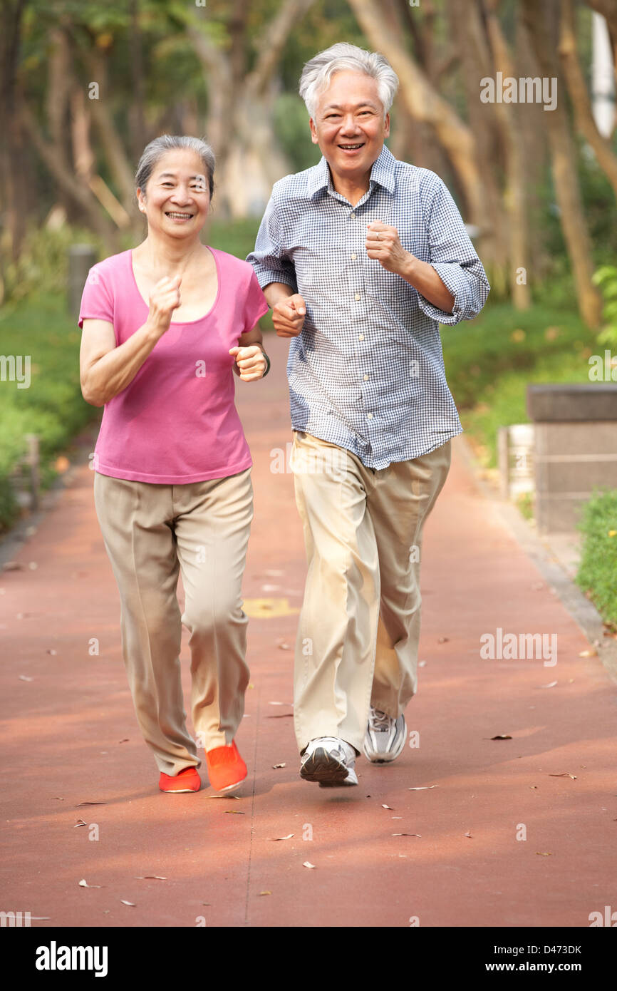 Senior Chinese Couple Jogging In Park Stock Photo - Alamy