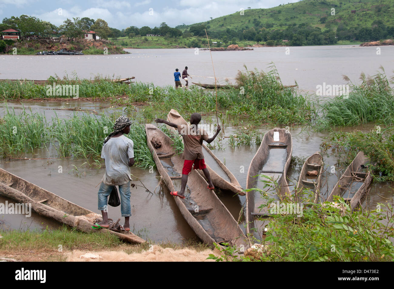 Central African Republic. August 2012. Bangui. Boys in canoes fishing ...