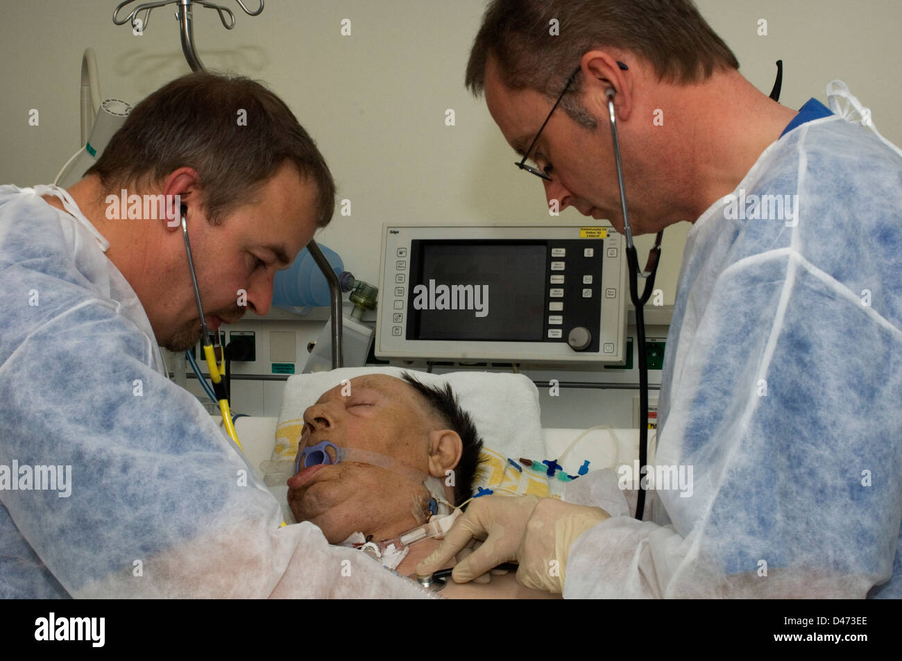 Doctors performing an endoscopic procedure on a man who has an ...