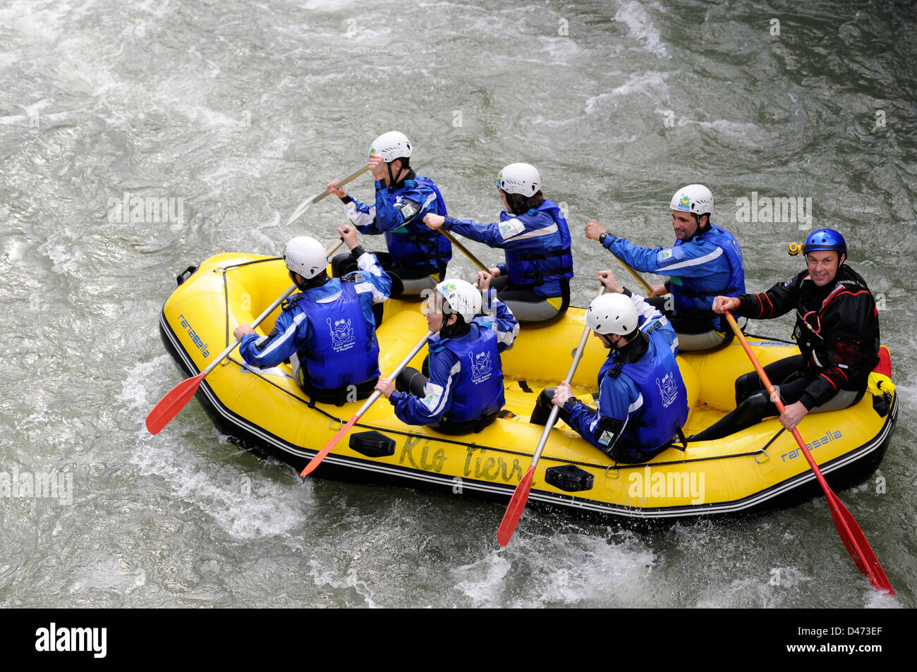 Young tourists practice rafting with a guide in Sella river in an ...