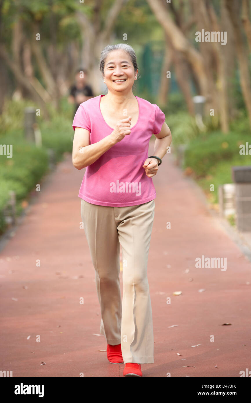 Senior Chinese Woman Jogging In Park Stock Photo - Alamy
