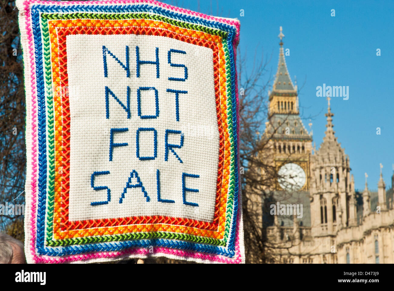Poster bright colours, embroidered with NHS NOT FOR SALE, outside ...
