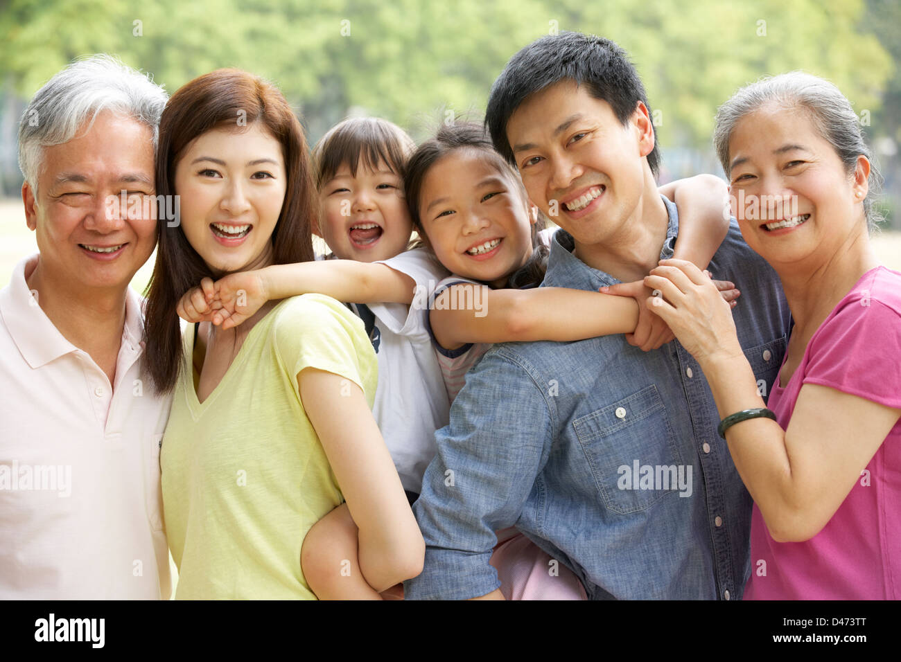 Portrait Of Multi-Generation Chinese Family Relaxing In Park Together ...
