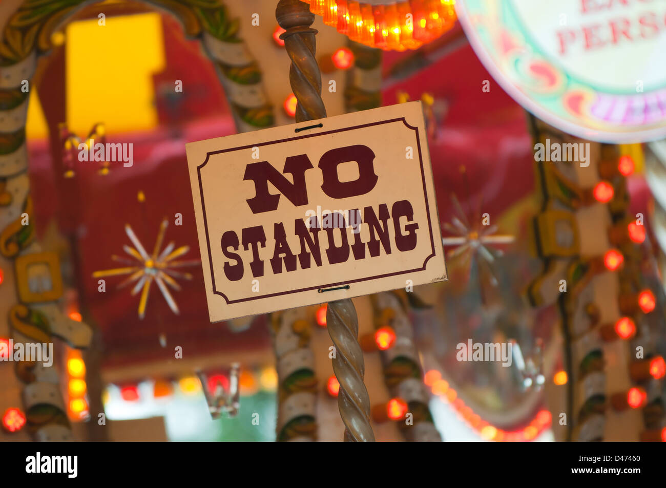 A no-standing sign on a fair ground ride Stock Photo - Alamy