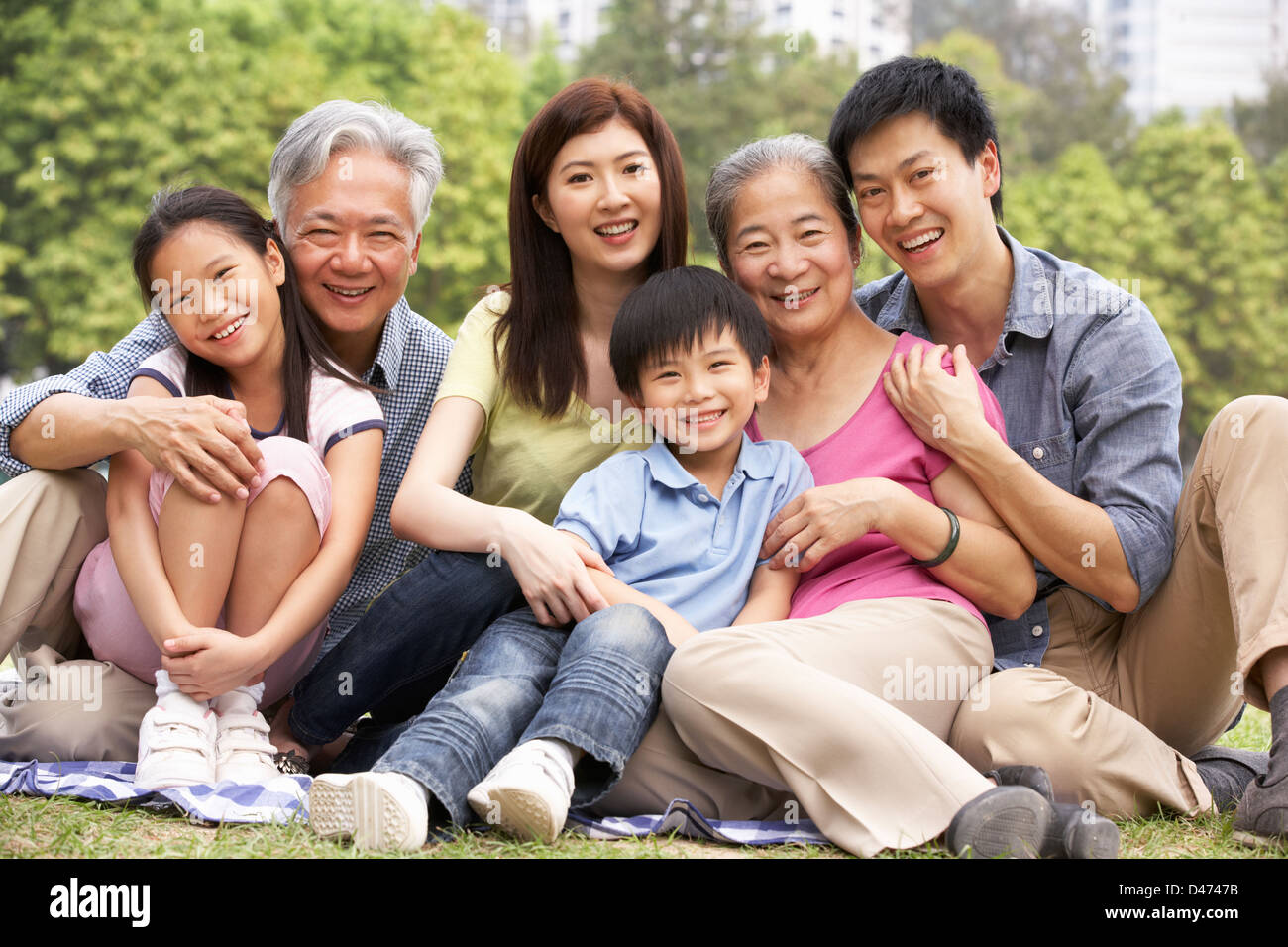 Portrait Of Multi-Generation Chinese Family Relaxing In Park Together ...