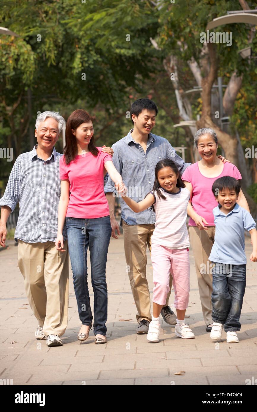 Portrait Of Multi-Generation Chinese Family Walking In Park Together ...