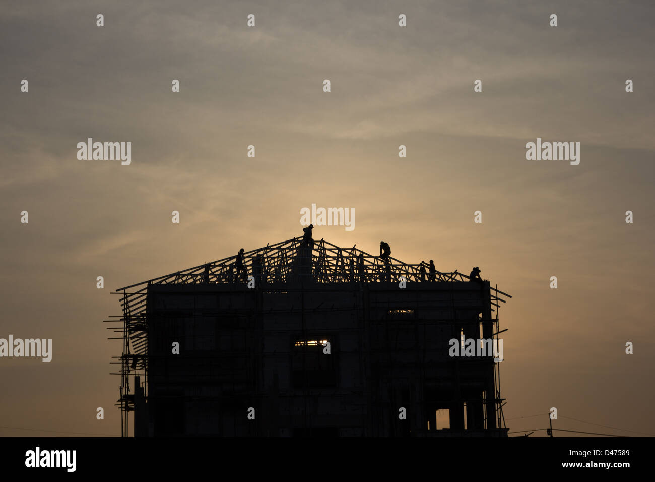 worker on construction site at sunset Stock Photo - Alamy