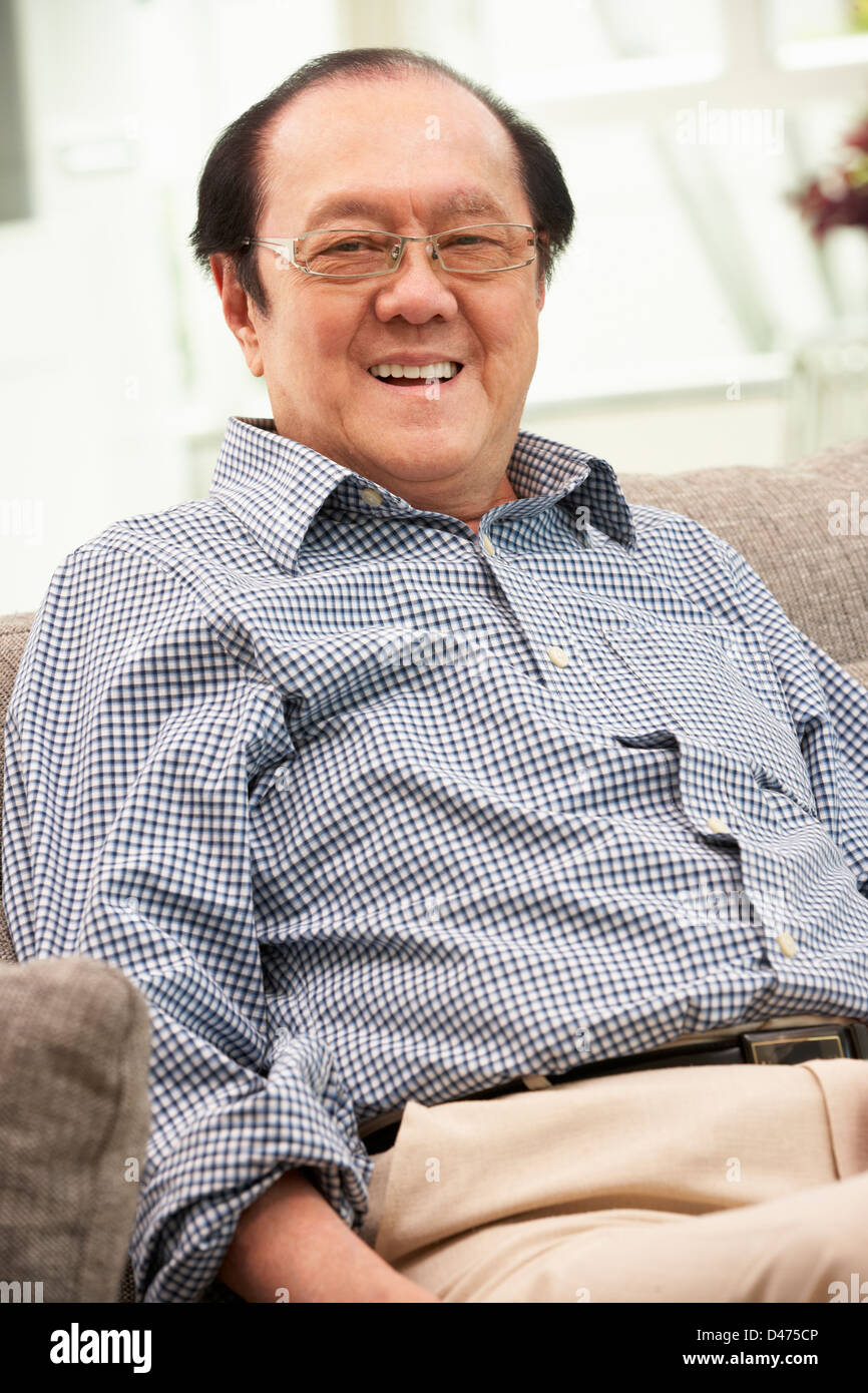 Senior Chinese Man Relaxing On Sofa At Home Stock Photo - Alamy