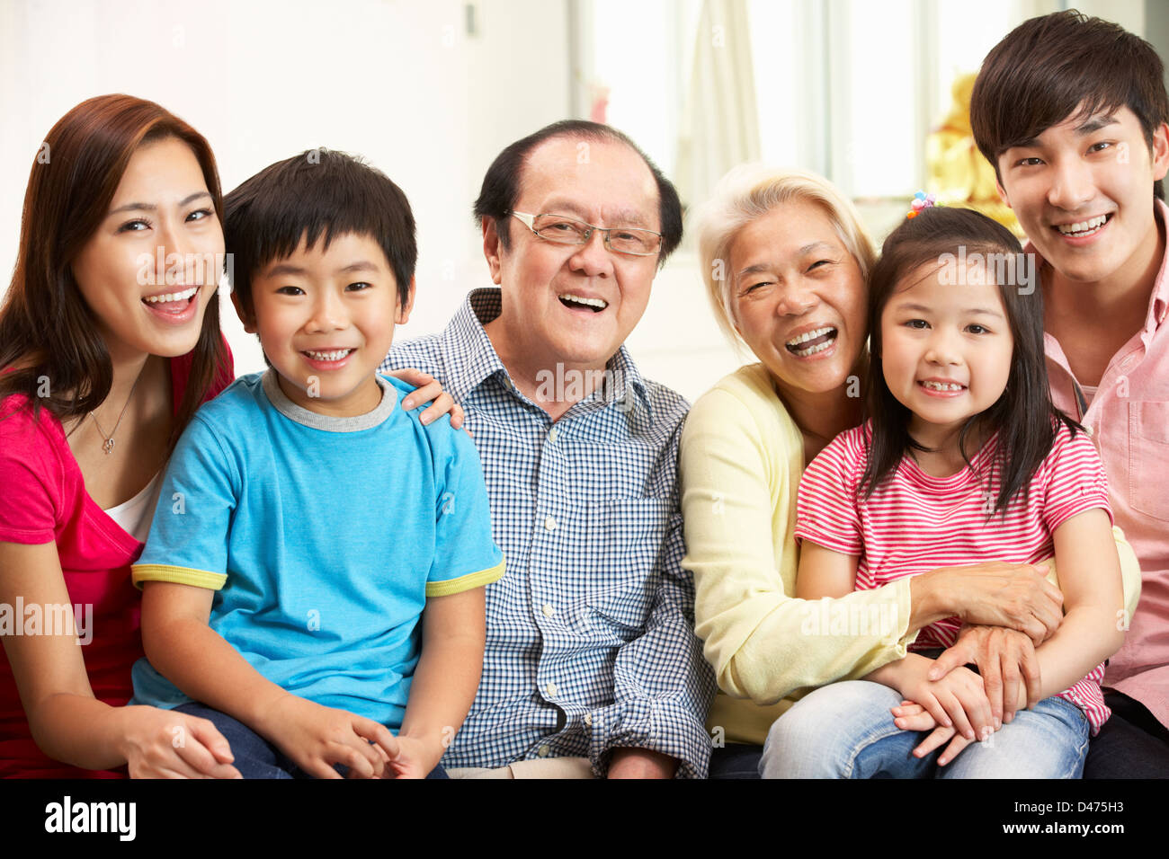Portrait Of Multi-Generation Chinese Family Relaxing At Home Together ...