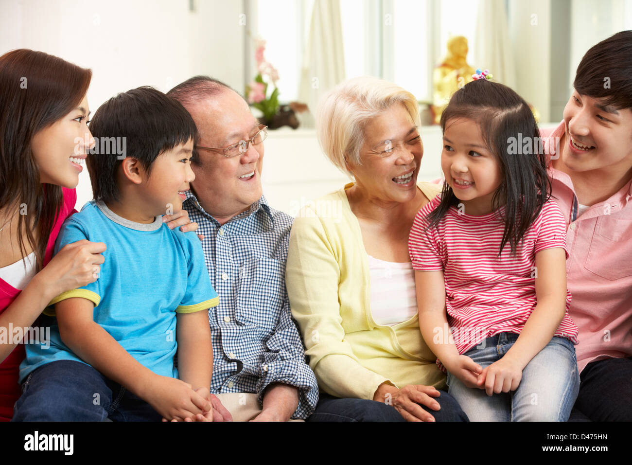 Portrait Of Multi-Generation Chinese Family Relaxing At Home Together ...