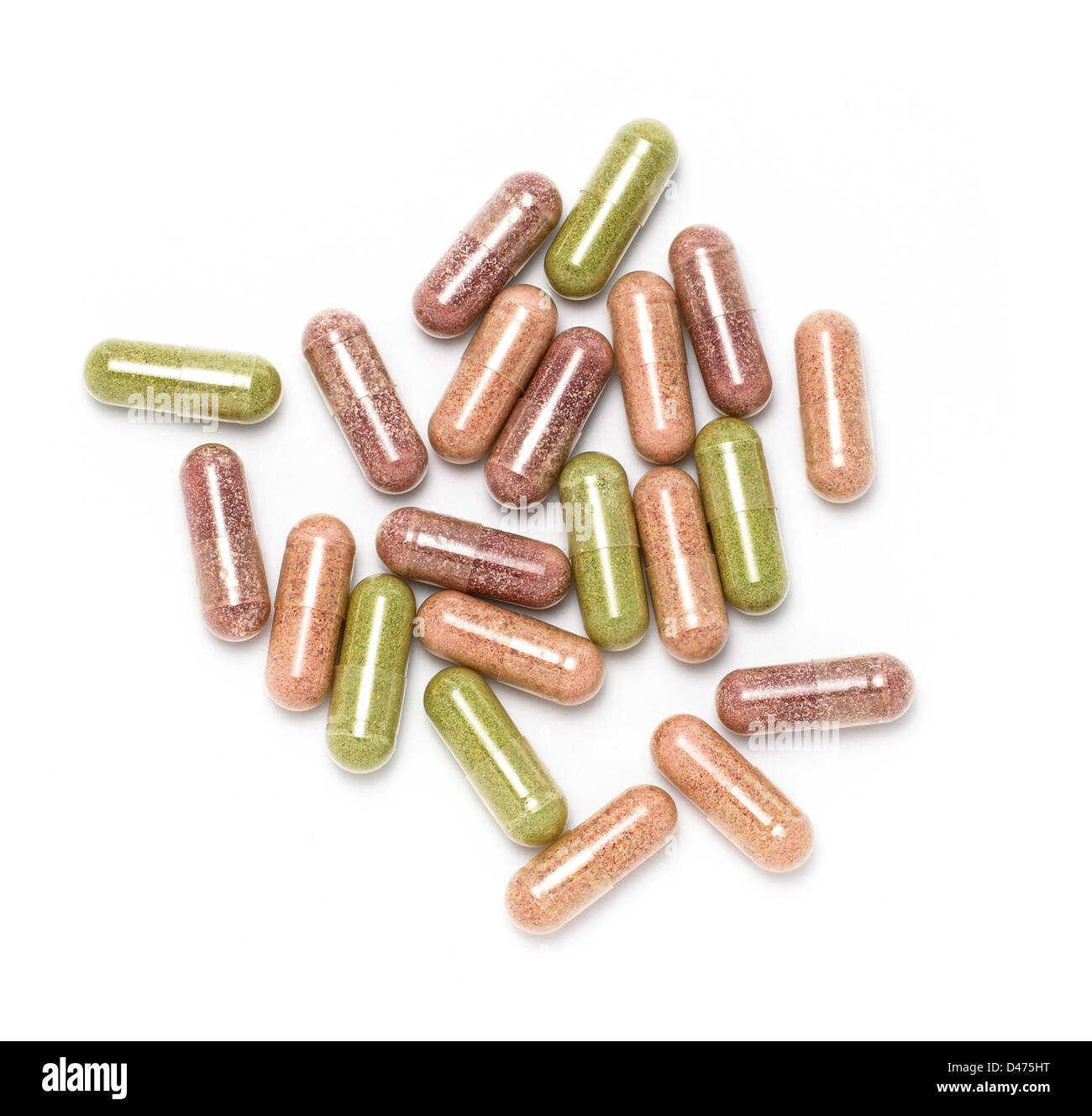 Assortment of different coloured capsules cut out white background ...
