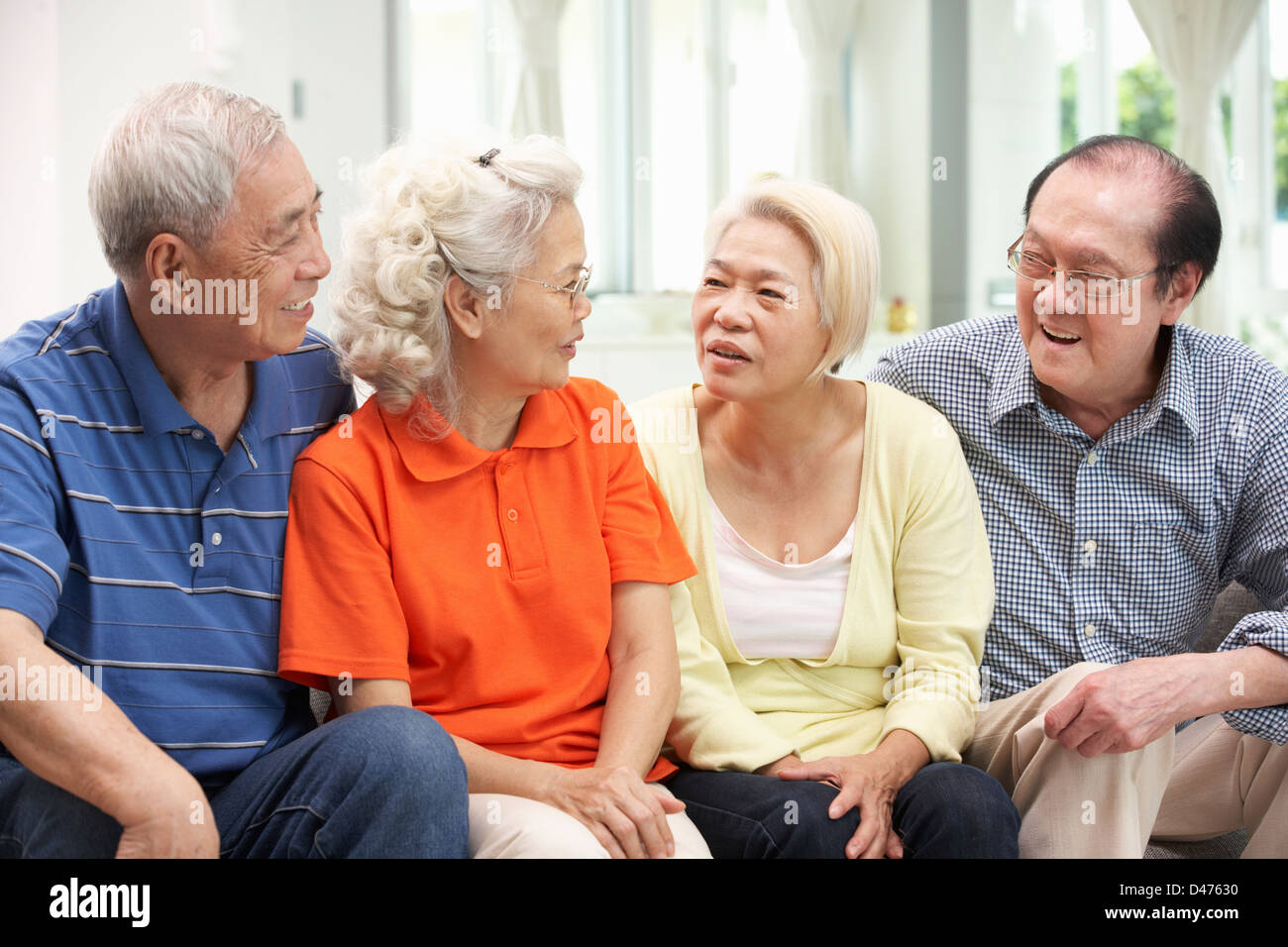 Group Of Senior Chinese Friends Relaxing On Sofa At Home Stock Photo ...