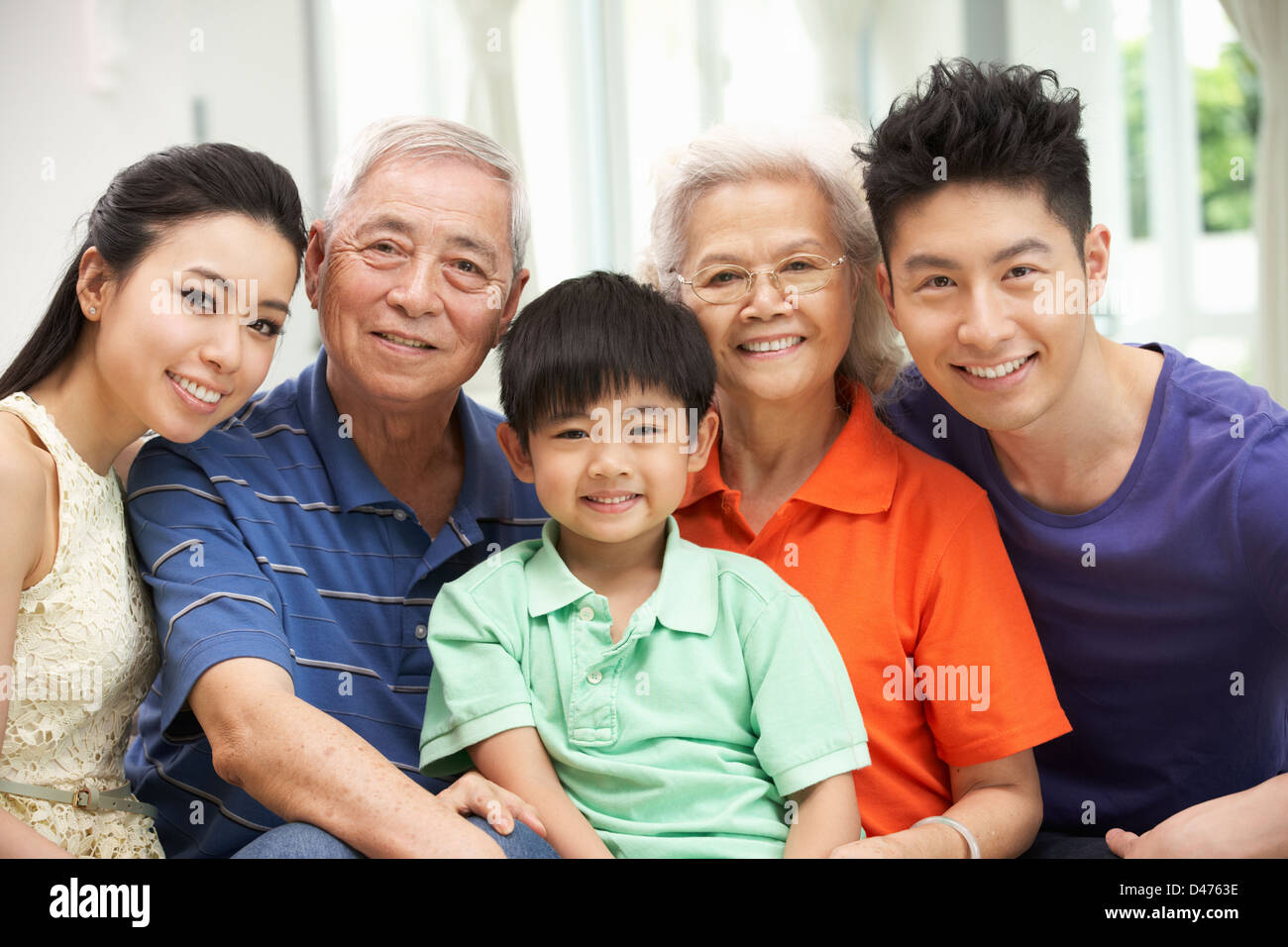 Portrait Of Multi-Generation Chinese Family Relaxing At Home Together ...