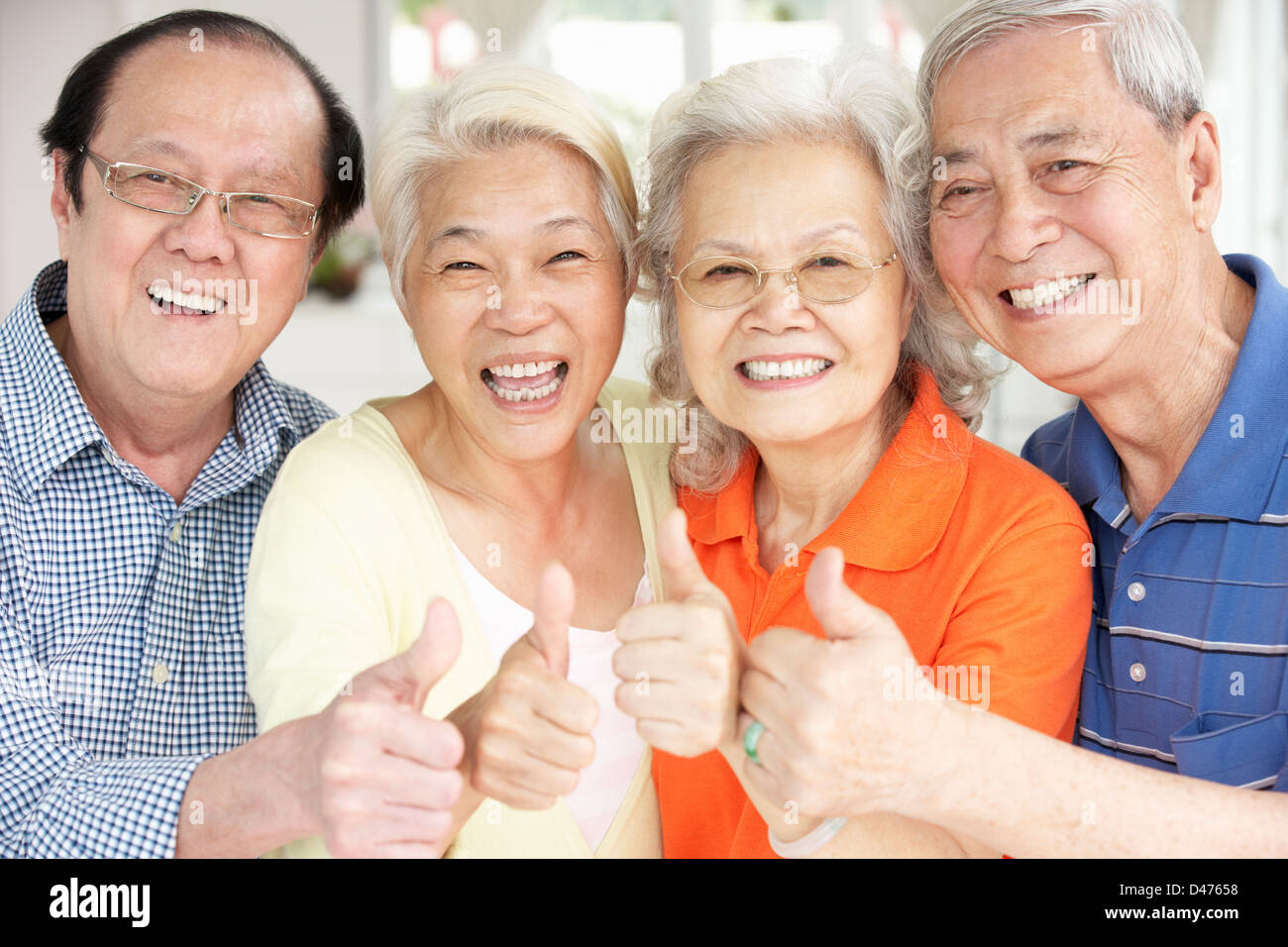 Group Of Senior Chinese Friends Relaxing On Sofa At Home Stock Photo ...