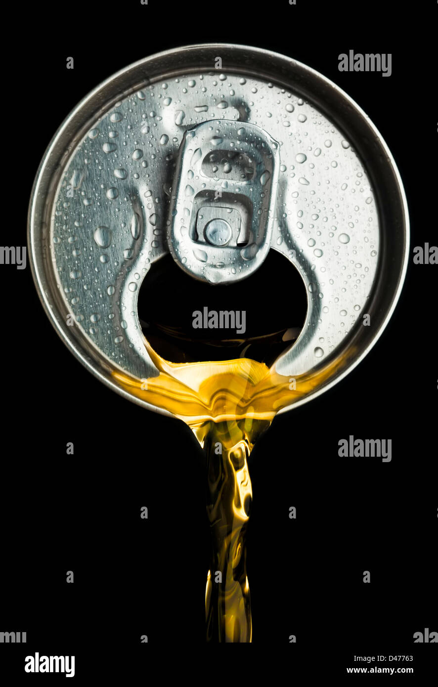 Beer flowing from a tin can, black background Stock Photo - Alamy