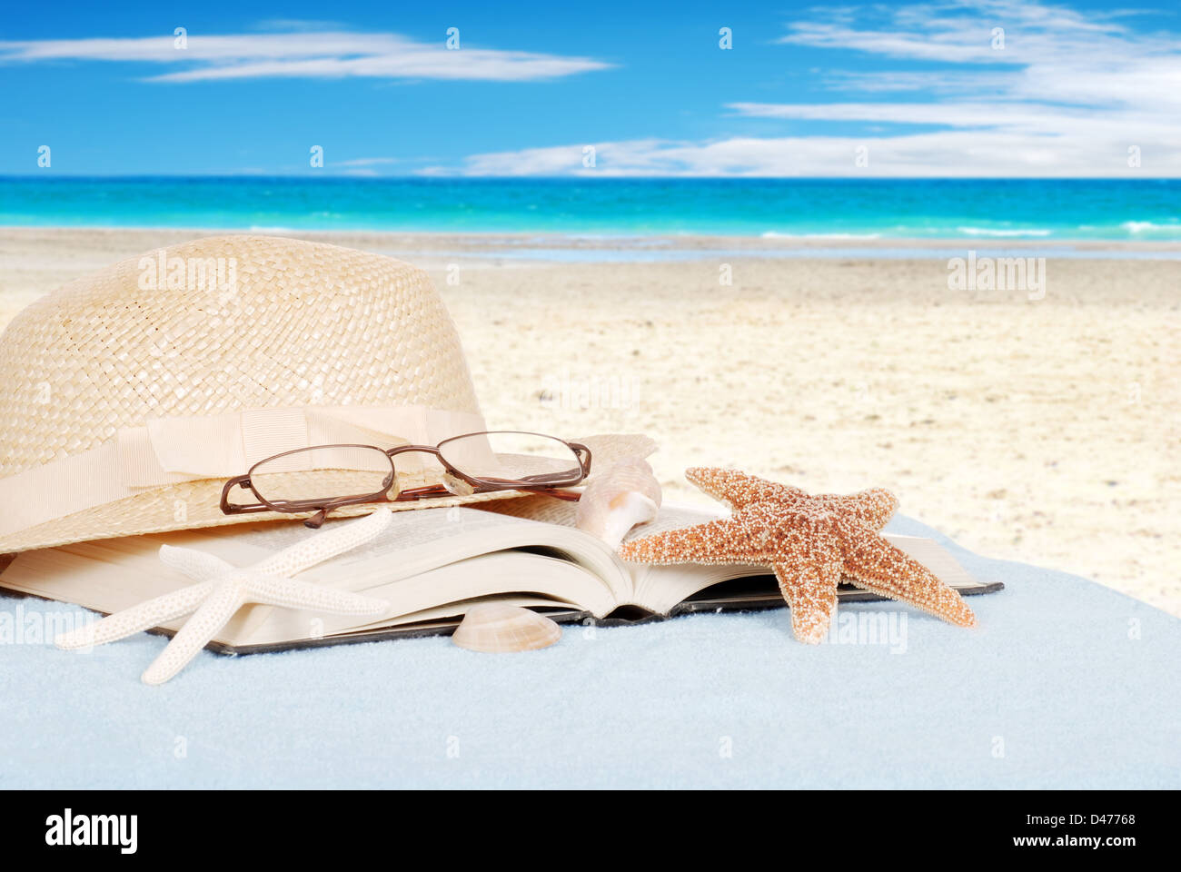 Still life beach concept with book glasses and hat Stock Photo - Alamy