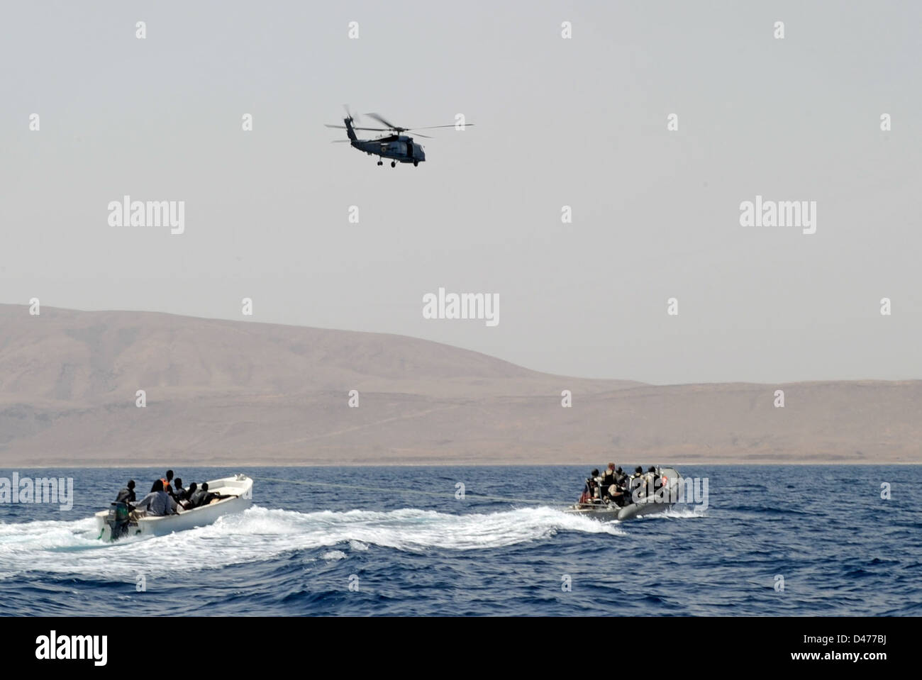 A VBSS team from USS Anzio tows a skiff with seven Somali mariners in ...