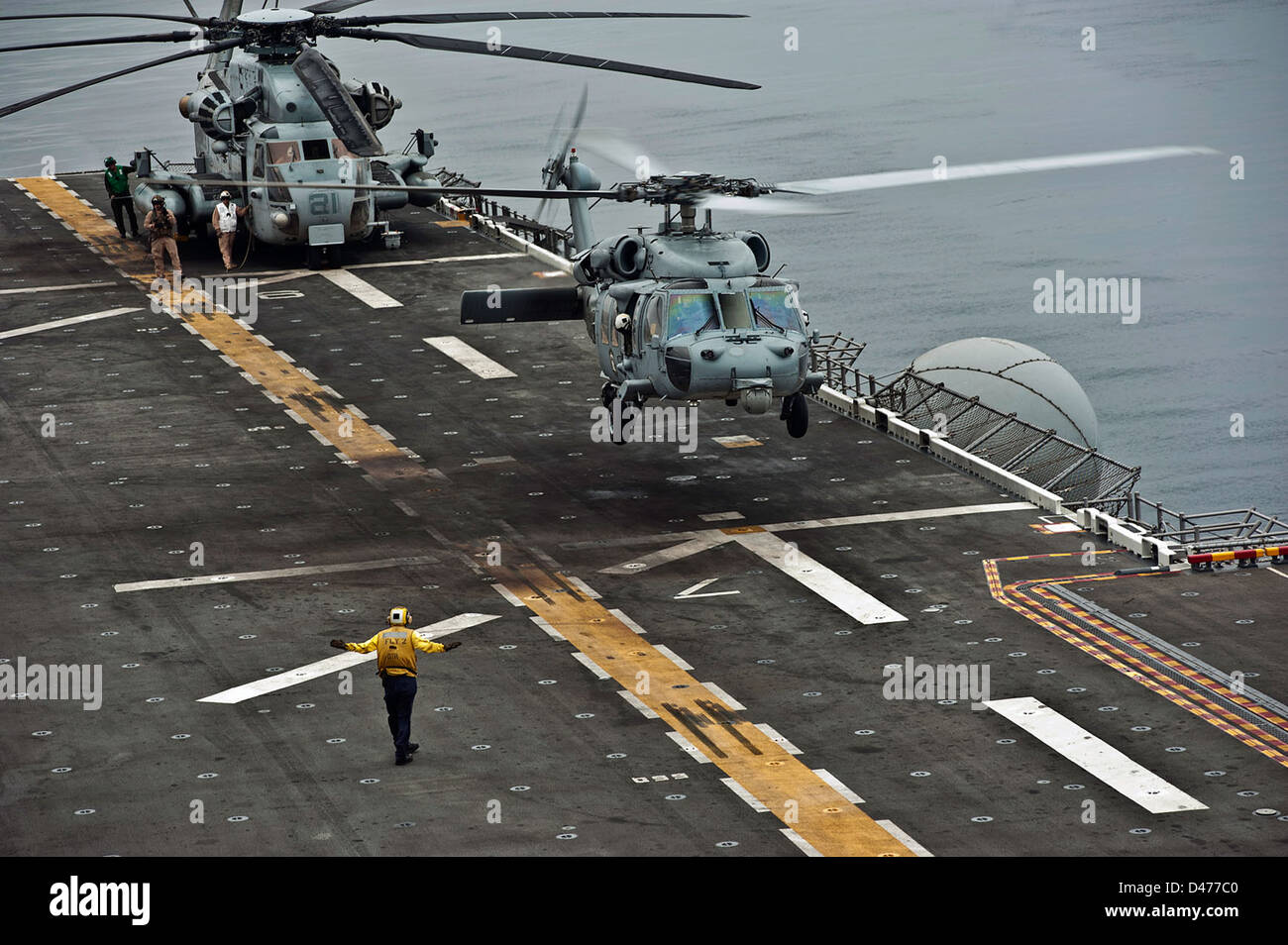 An MH-60S Sea Hawk helicopter successfully lands aboard the USS Makin ...