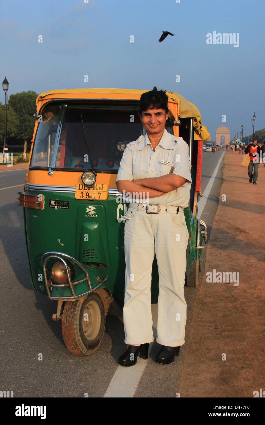 Rickshaw driver Sunita Chaudhry stands beside her vehicle and smiles on ...
