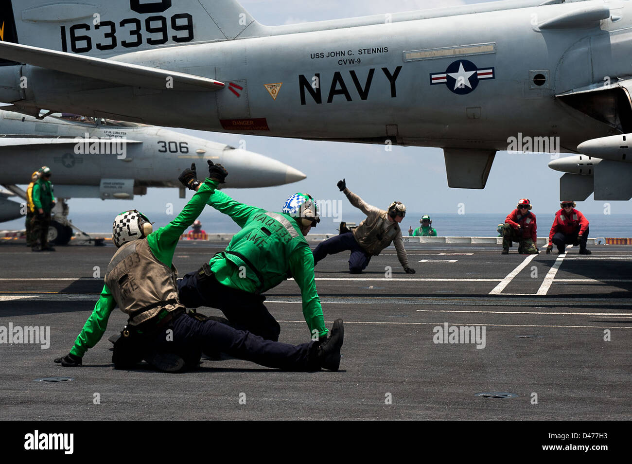 Sailors aboard a U.S. Navy ship provide launch approval for the EA-6B ...