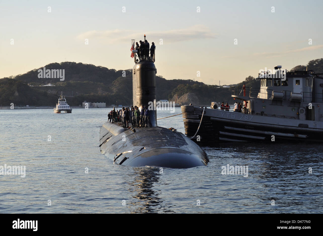 The image depicts a U.S. Navy operation, specifically focusing on naval ...