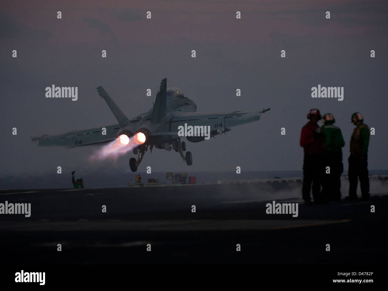 A jet launches from the flight deck of a Navy aircraft carrier during ...
