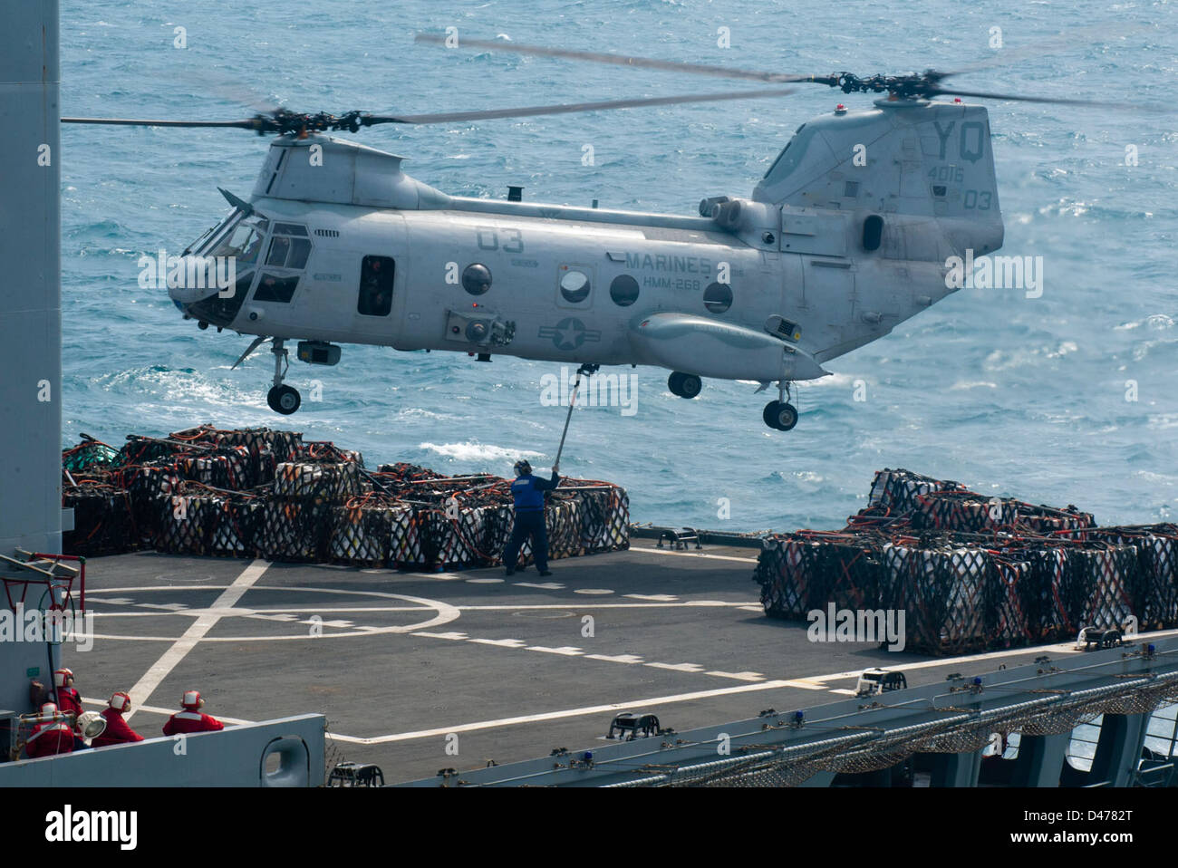 Helicopters transfer cargo during a replenishment at sea Stock Photo ...