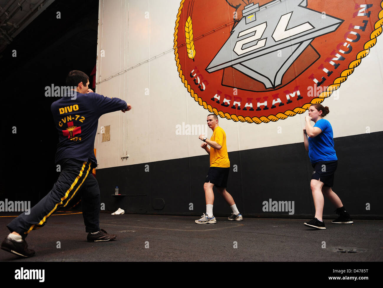 A Sailor demonstrates mixed martial arts techniques in the hangar bay ...