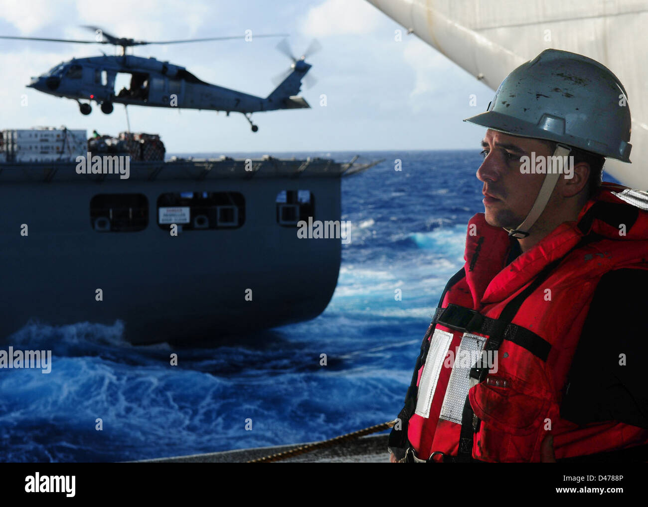 A U.S. Navy Sailor aboard a vessel in the Pacific Ocean waits for ...