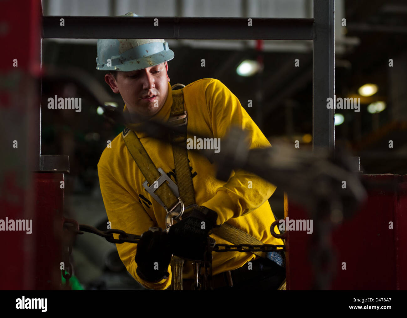 A Sailor tightens support chains for a forklift Stock Photo - Alamy