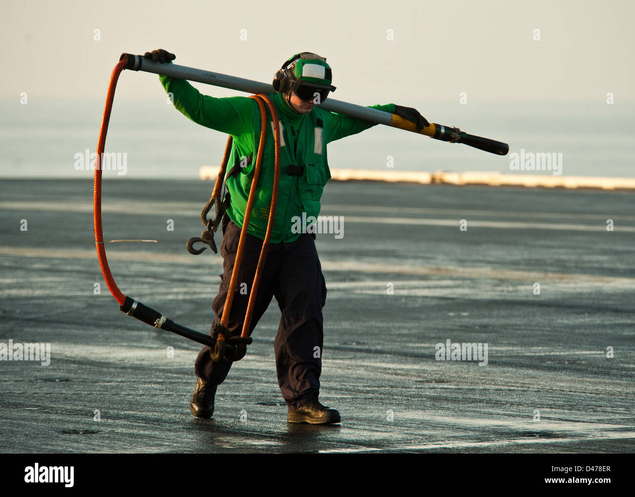 A Sailor transports a hook across the flight deck aboard a U.S. Navy ...