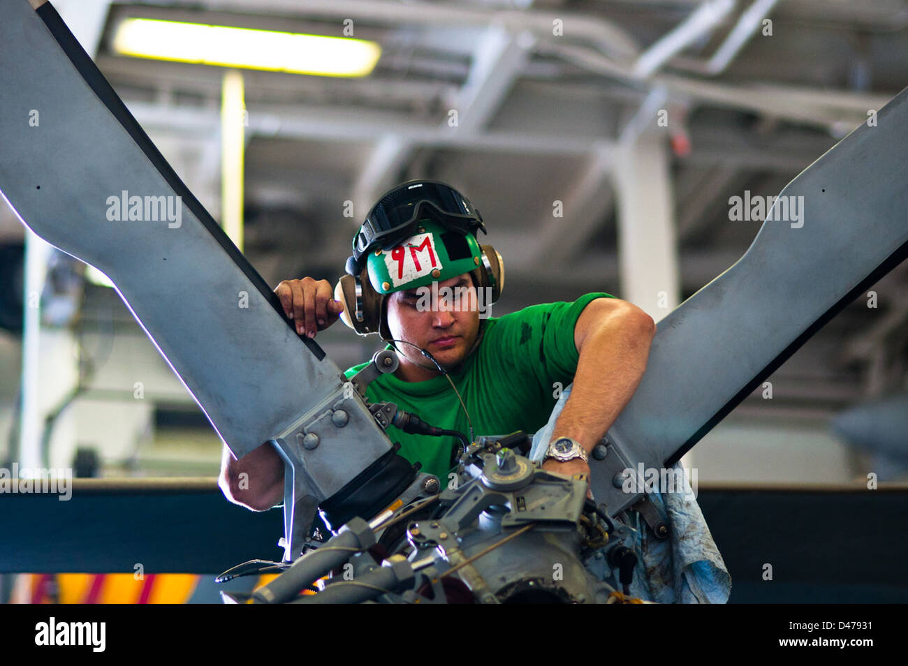 Aviation Structural Mechanic 2nd Class Michael Musser maintains the ...