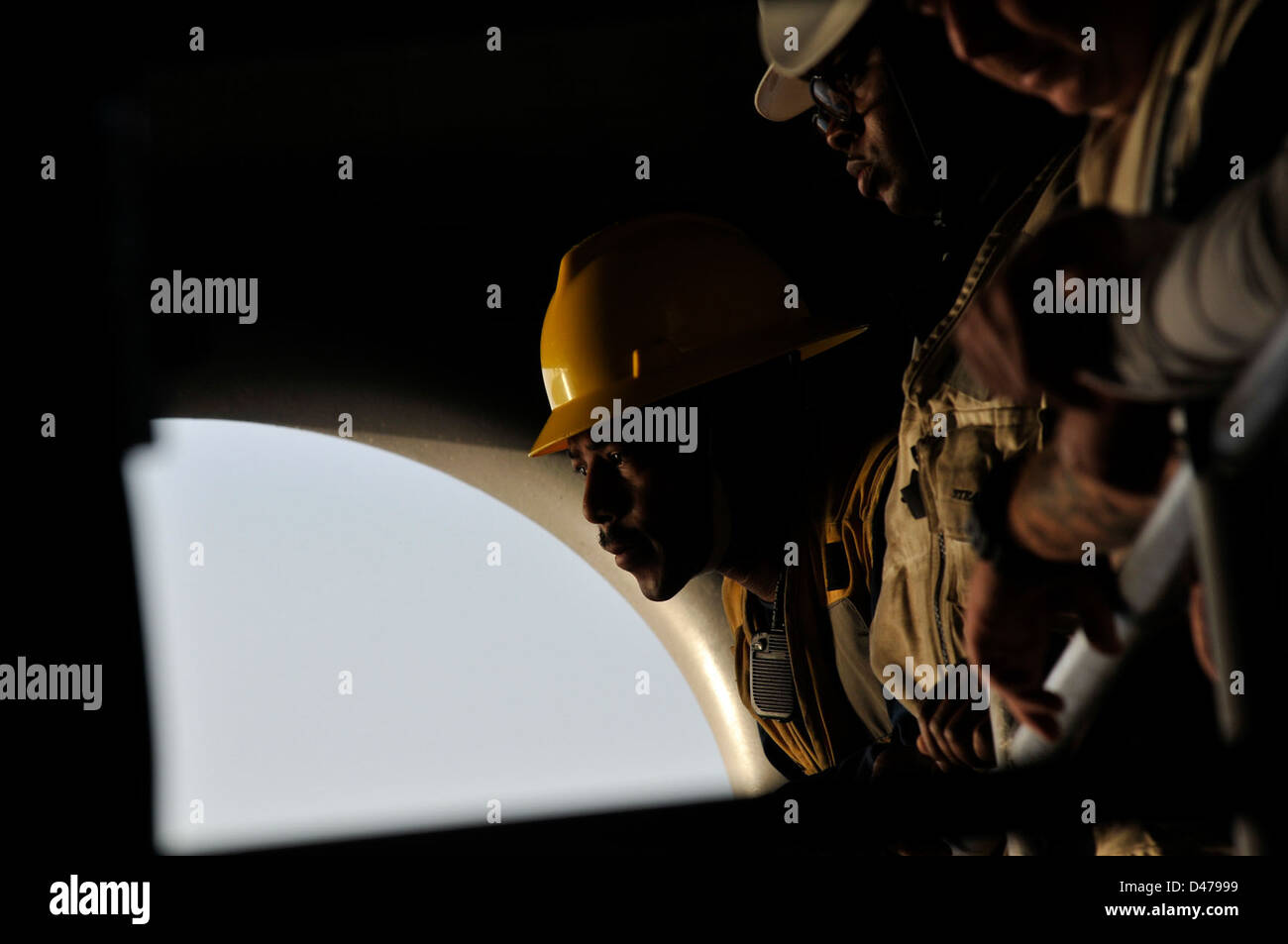 Sailors stand safety watch aboard a U.S. Navy ship as fellow sailors ...
