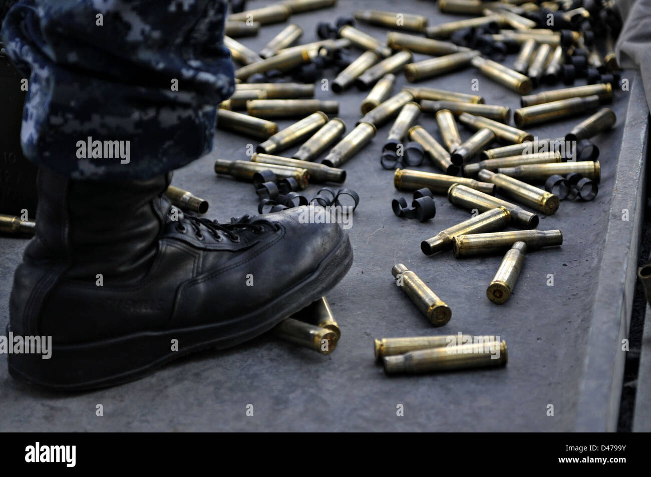Spent shell casings from a .50 caliber machine gun accumulate on the ...