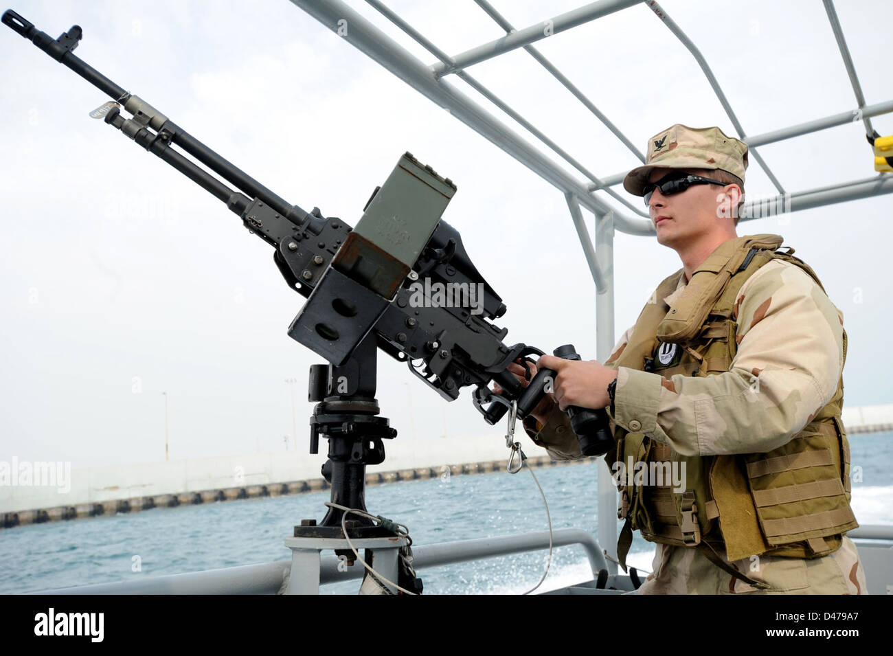 A U.S. Navy Sailor stands watch at Naval Base Kuwait, ensuring security ...