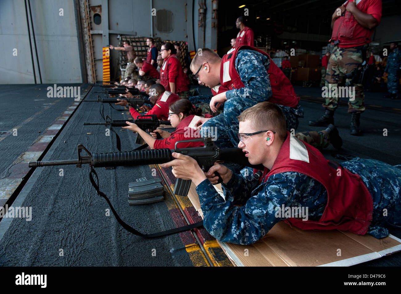 Sailors conduct small-arms qualification training in the Arabian Sea as ...