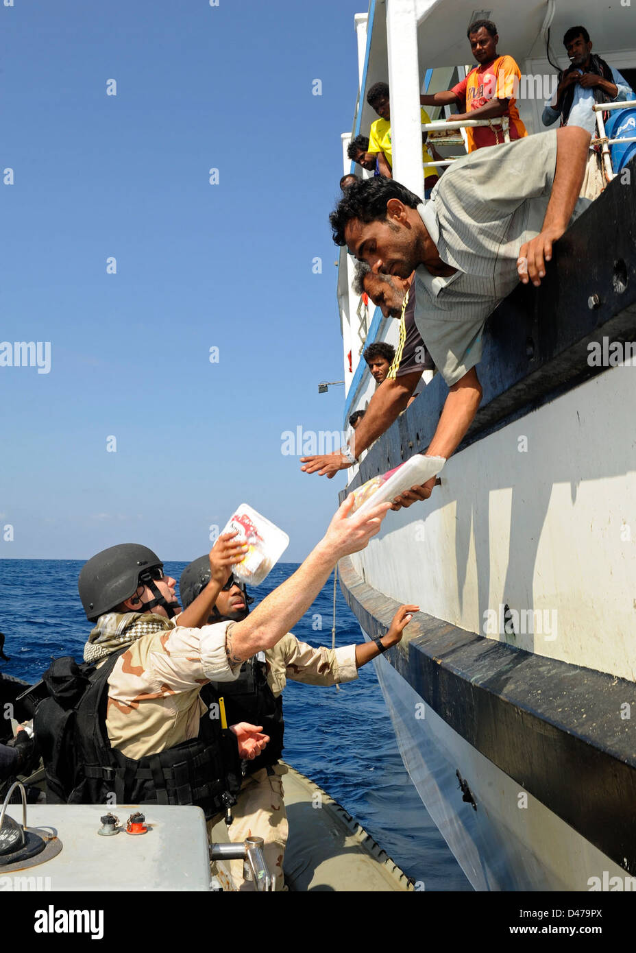 U.S. Navy Sailors provide food and water to distressed Iranian mariners ...