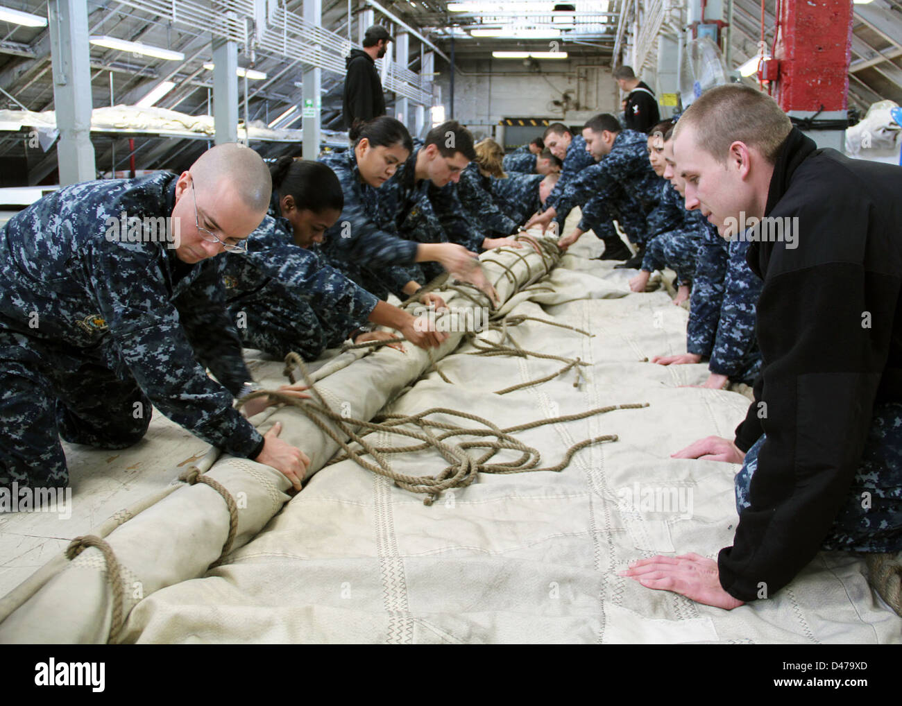 Crew members aboard the USS Constitution prepare the ship’s main ...