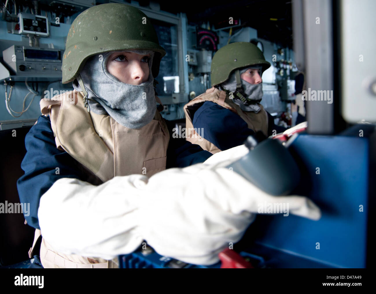 A Sailor operates a tactical console during a general quarters drill ...