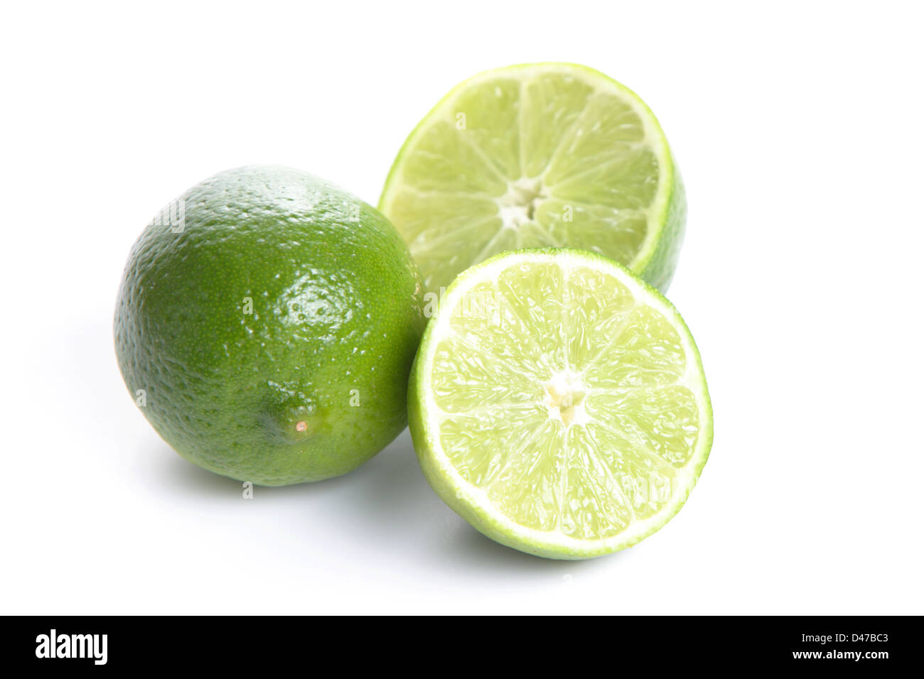 Limes cut in half isolated on white Stock Photo - Alamy