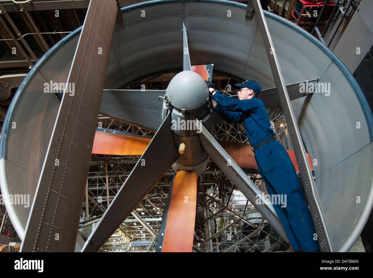 A Sailor performs maintenance on the propeller of an LCAC (Landing ...