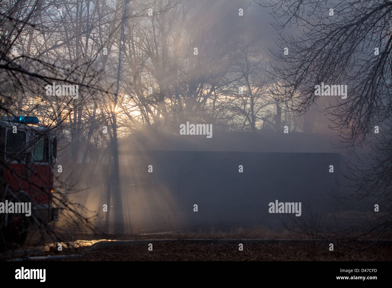Sunlight filters through the smoke from a house fire in Fernley Nevada ...