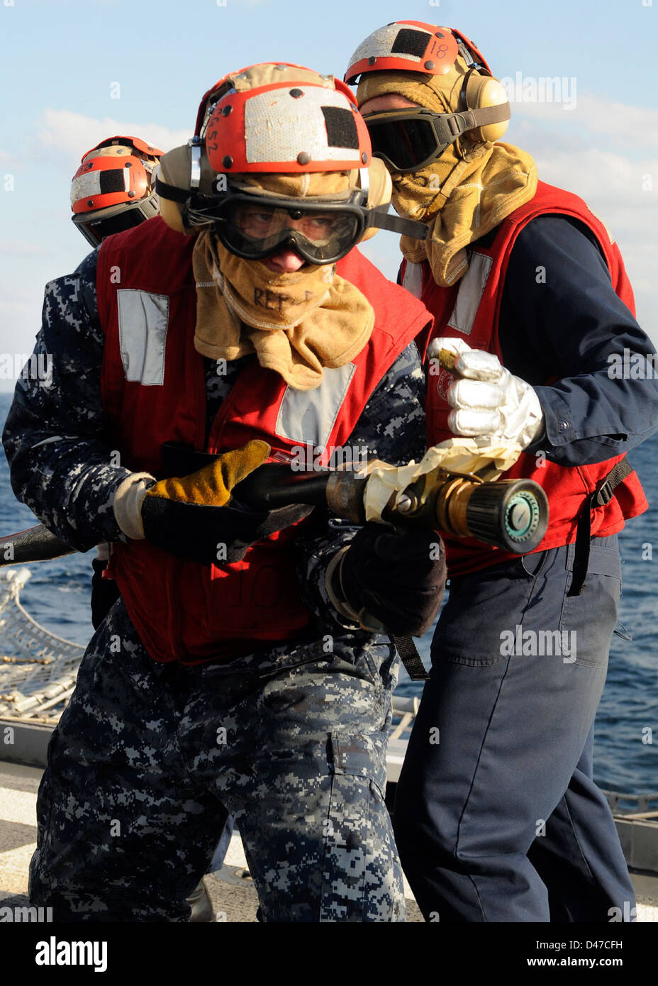 Sailors aboard a U.S. Navy ship practice firefighting techniques in the ...
