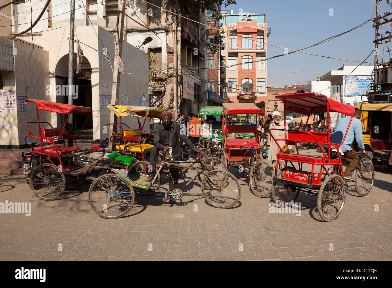 Busy Amritsar street scene with cycle rickshaws and drivers Stock Photo ...
