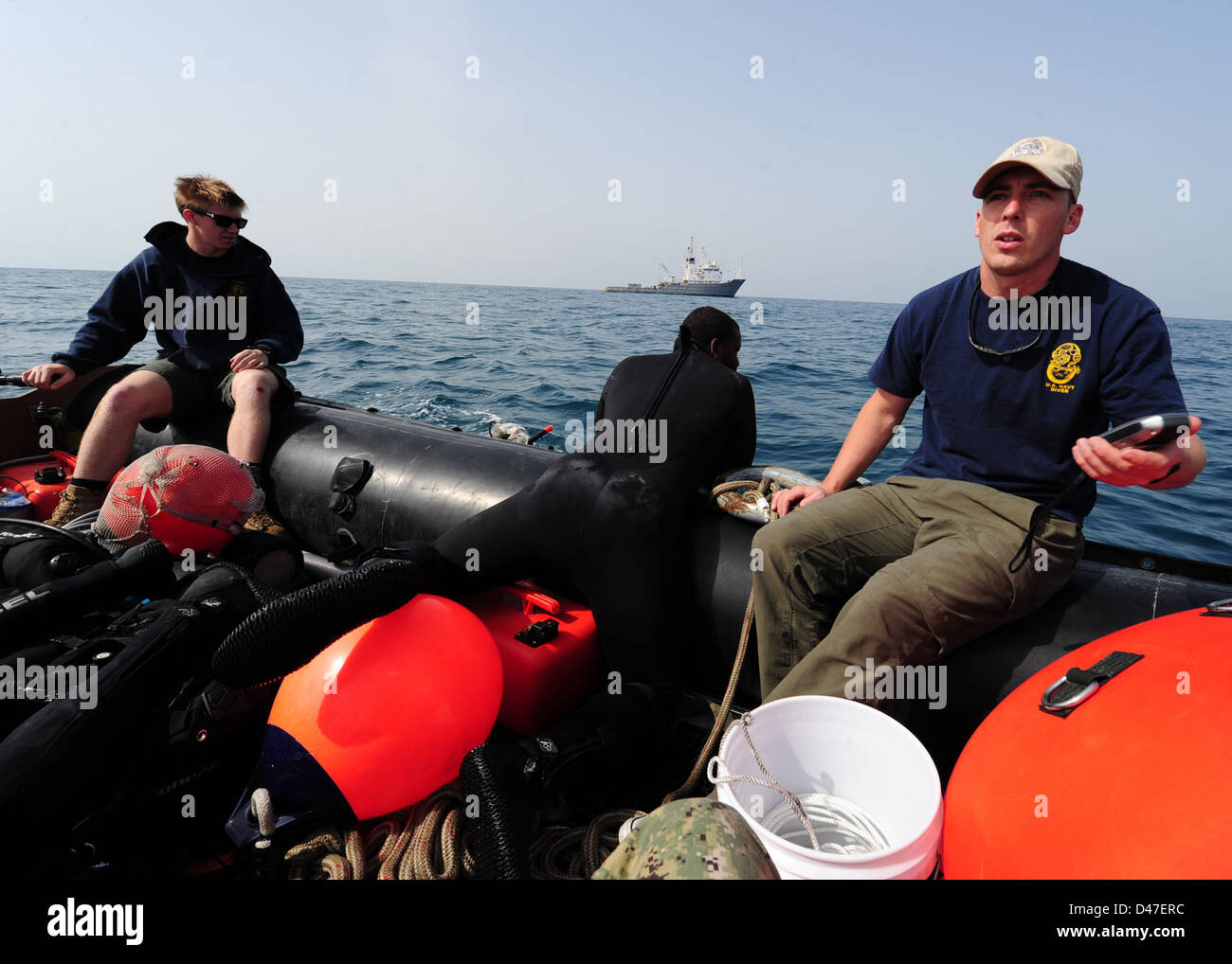 Navy divers conduct a search for inert mine shapes during a training ...