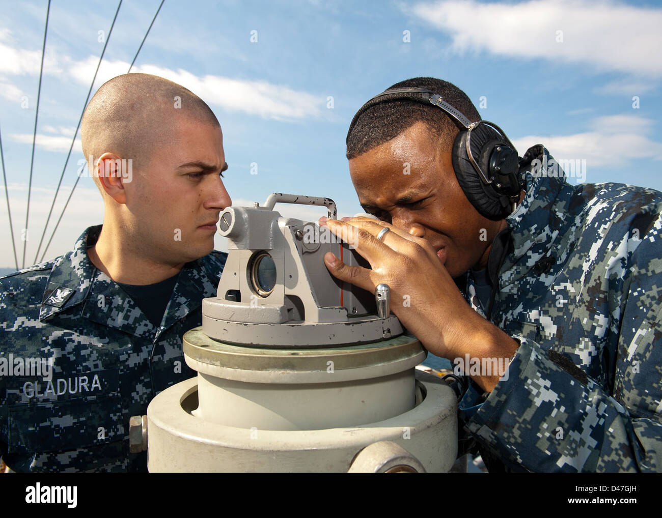 Sailors aboard the USS Enterprise operate a telescopic alidade, a ...