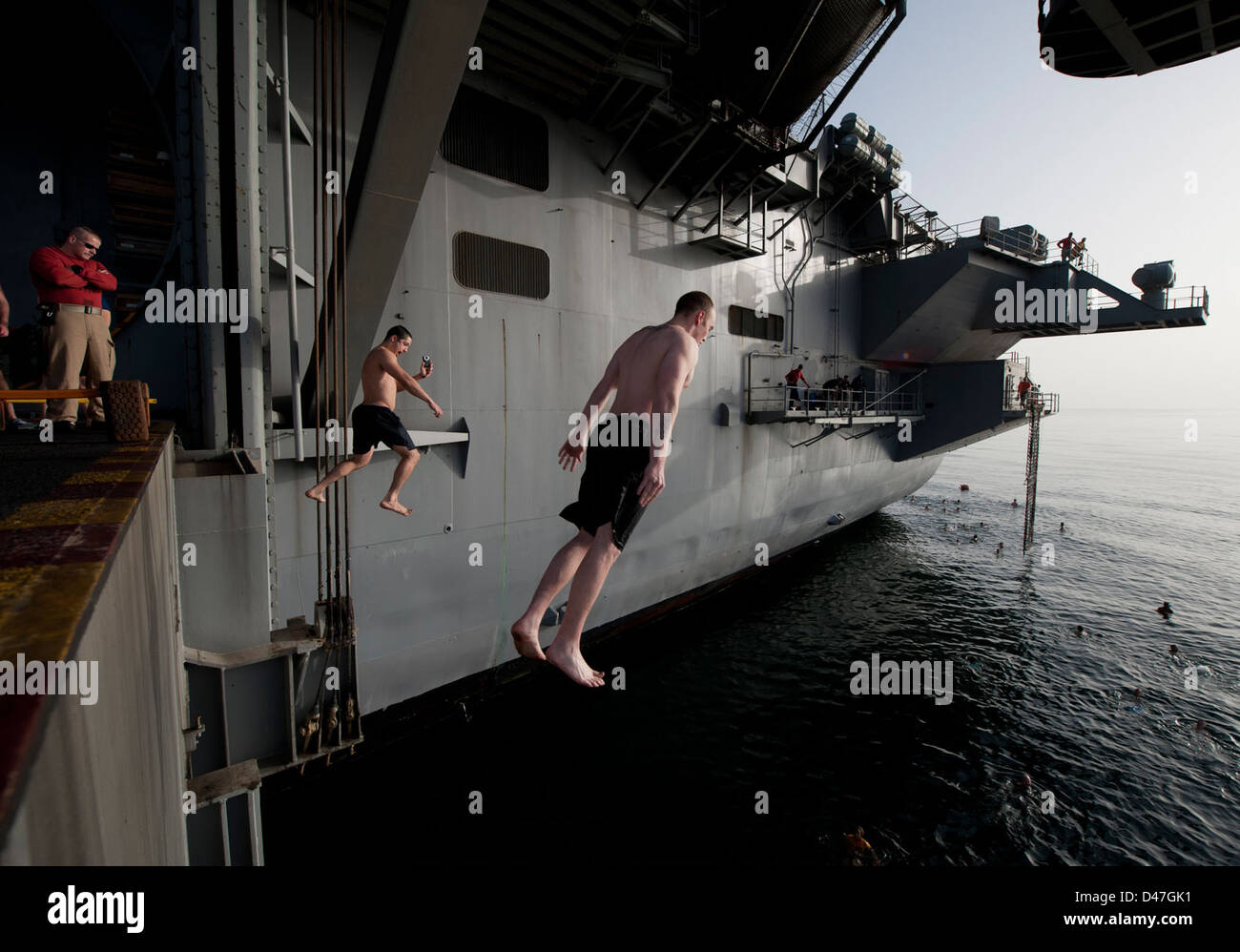 Sailors jump off aircraft elevator hi-res stock photography and images ...